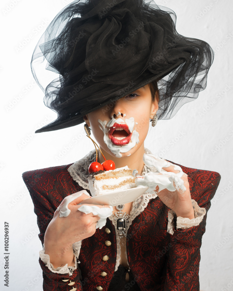 Girl eating cake with cherry and soiled in a cream Stock Photo | Adobe ...