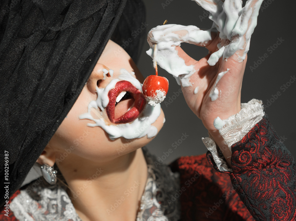 Girl messy eating cake with cherry Stock Photo | Adobe Stock
