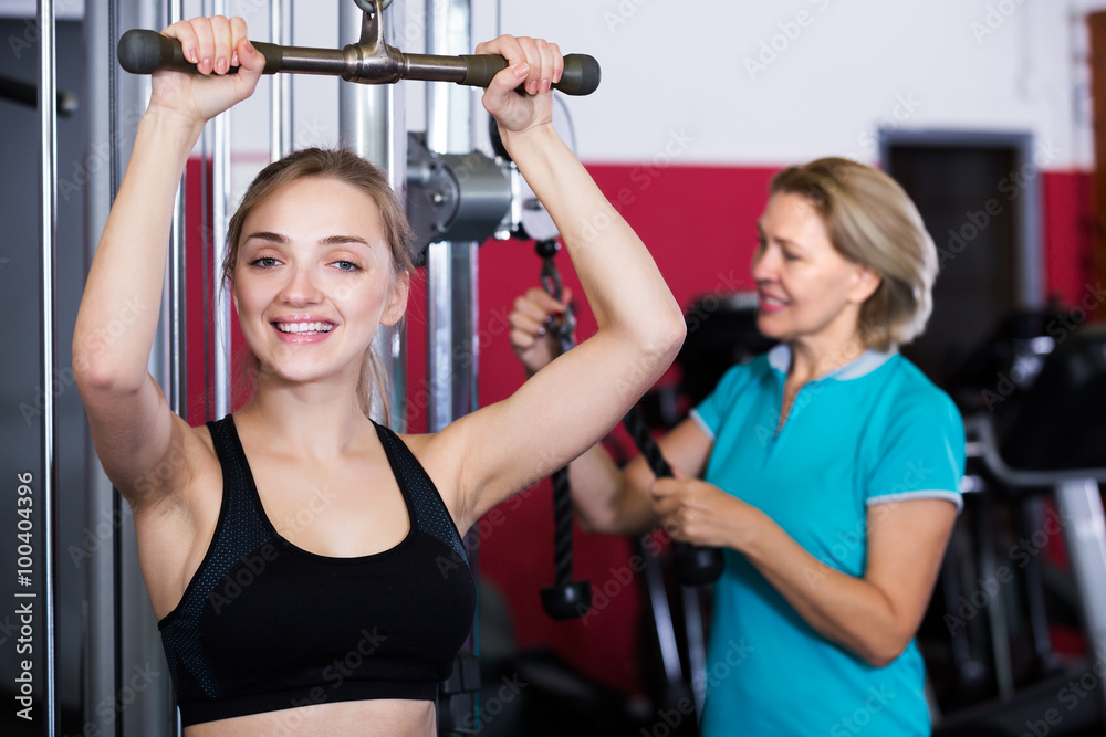 Women doing powerlifting on machines Stock Photo | Adobe Stock