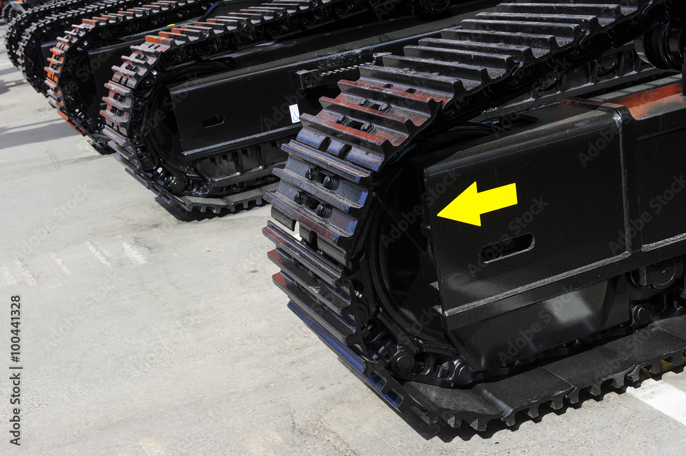 Row of bulldozer and excavator tracks with drive gears with sprocket ...