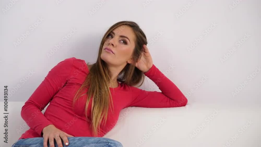 Woman thinking sitting on sofa couch 4K. Stock Video | Adobe Stock