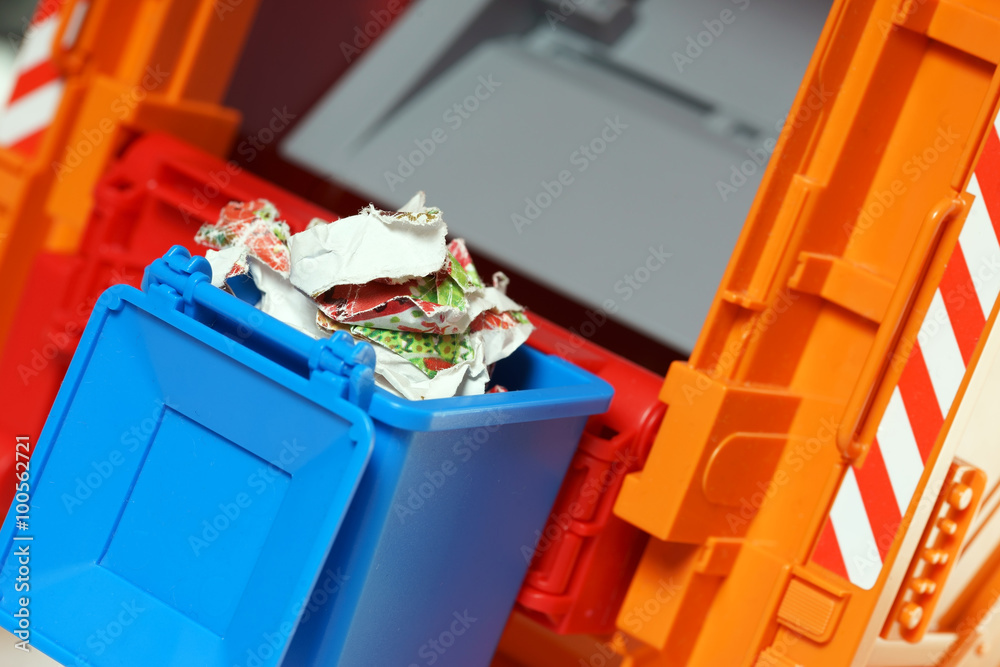 Paper Waste / blue paper bin with paper waste in front of a garbage ...
