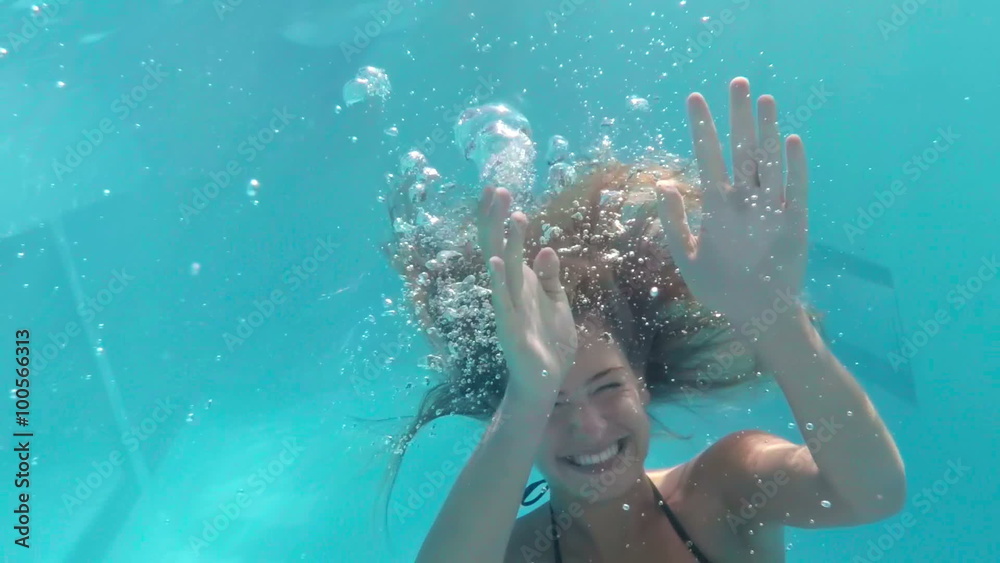 Pretty woman swimming underwater in pool Stock Video | Adobe Stock