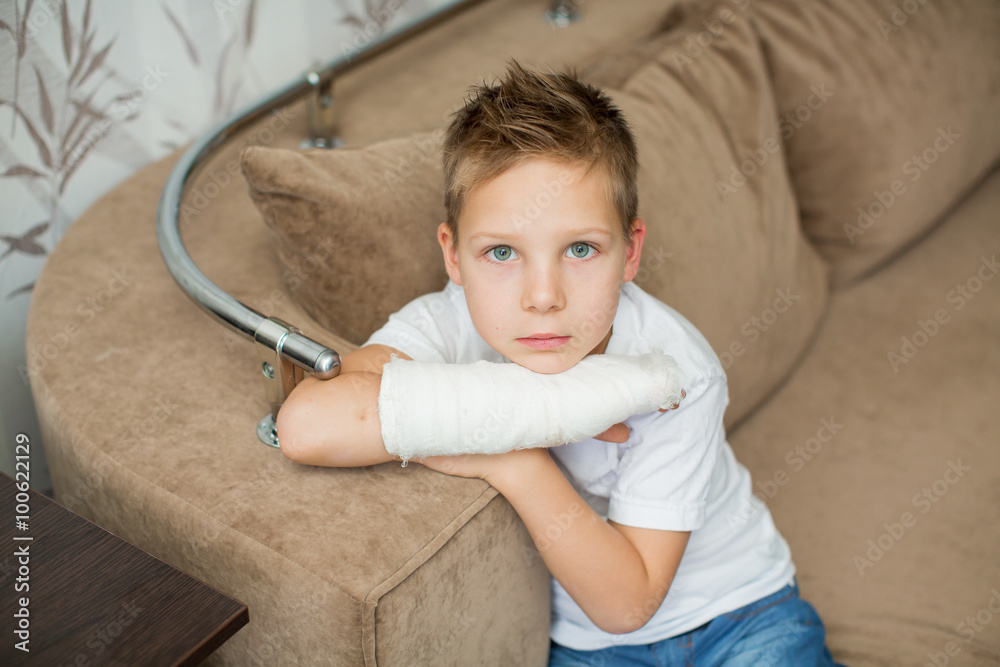 little boy with a broken arm. child in a cast. funny kid after accident ...
