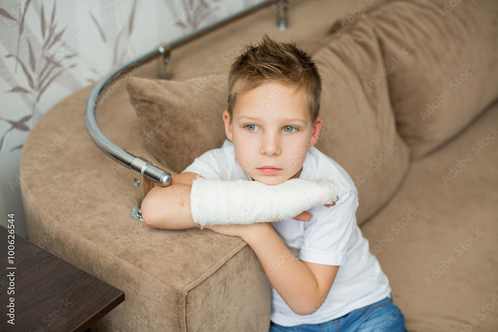 little boy with a broken arm. child in a cast. funny kid after accident ...