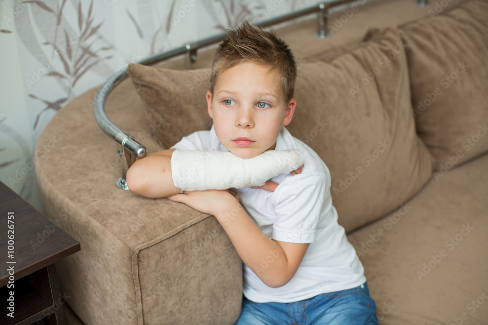 little boy with a broken arm. child in a cast. funny kid after accident ...