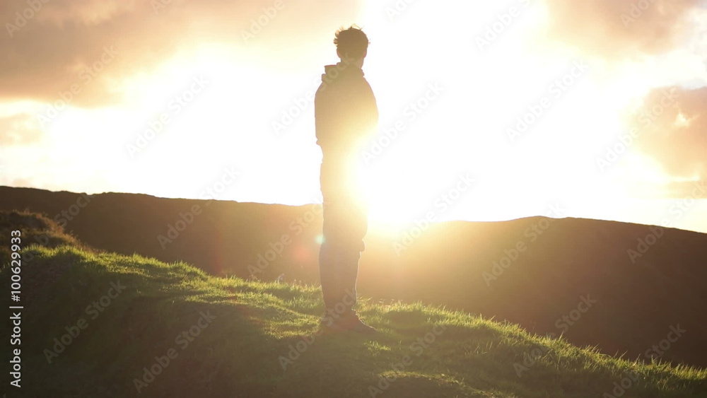Caucasian man staring into the sunset, while seagulls flying in the ...