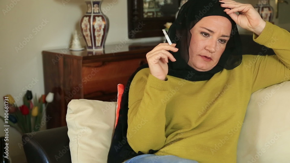 Sad muslim woman smoking cigarette Stock Video | Adobe Stock