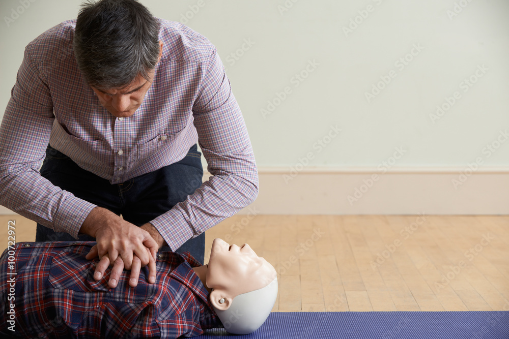 Man Using CPR Technique On Dummy In First Aid Class Stock Photo | Adobe ...