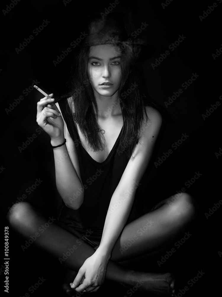 Beautiful girl portrait sitting and smoking cigarette black and white ...