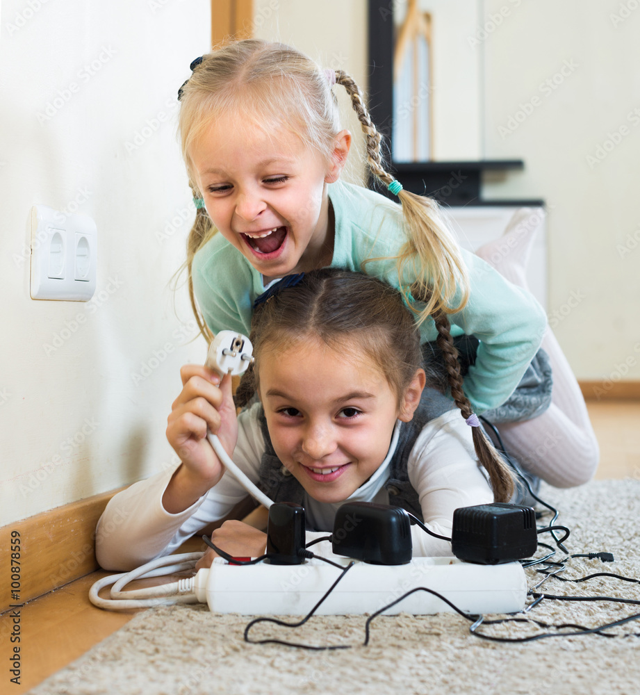 children playing with sockets and electricity indoors Stock Photo ...