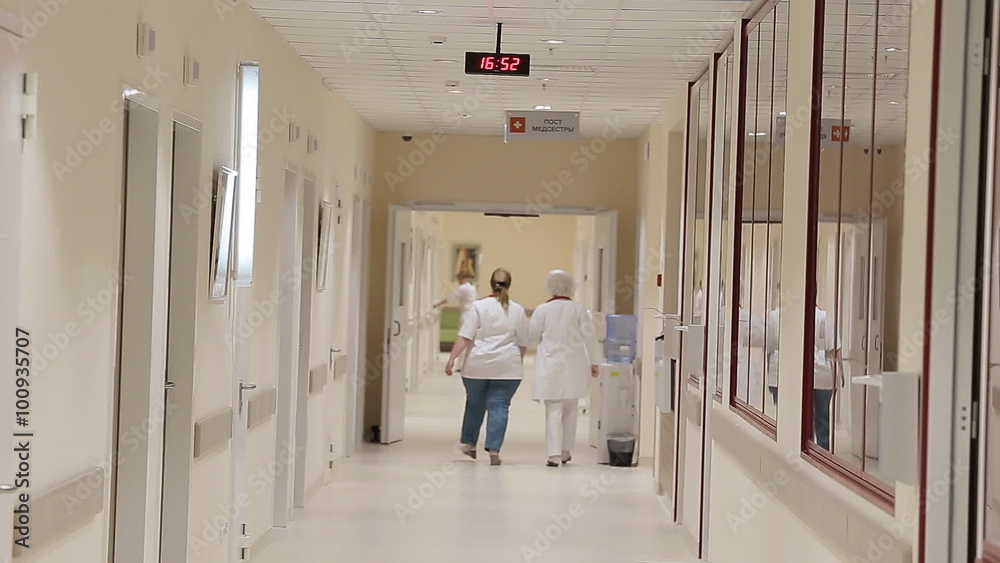 Doctor walking down hospital hallway Stock Video | Adobe Stock