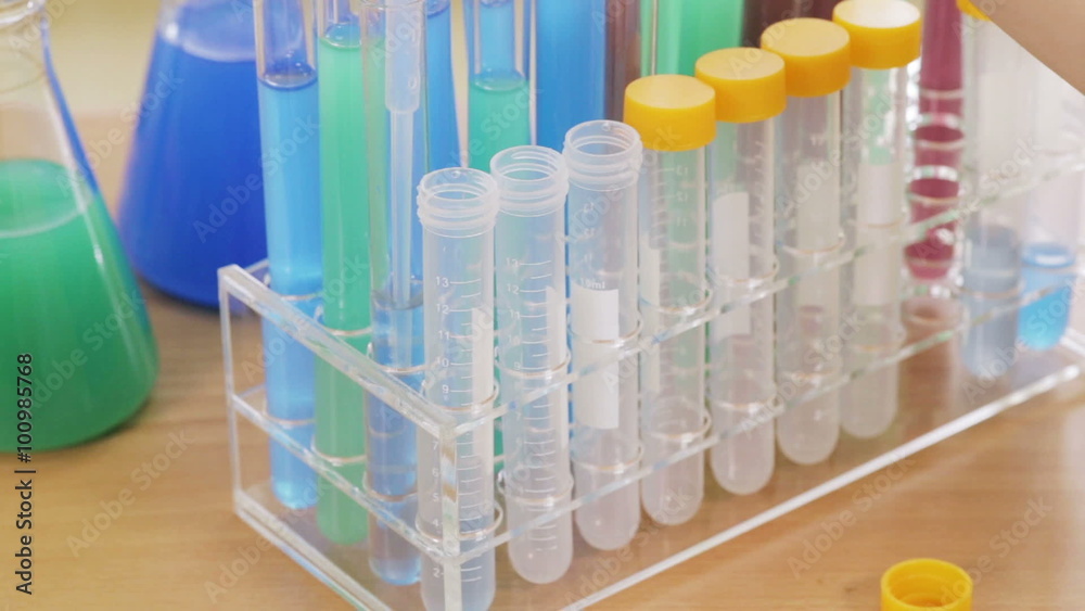 Transferring liquid from test tubes to sample tubes with pipette Stock ...