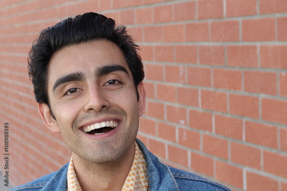 Cute boy with a giant smile on a rec brick wall background with ...