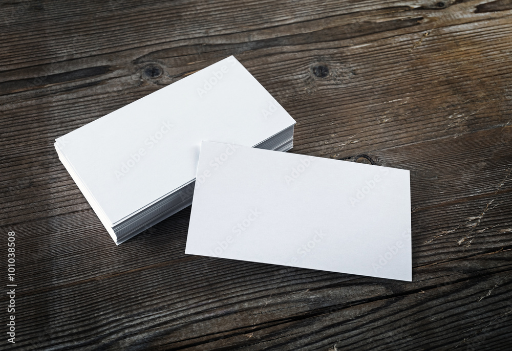 Photo of blank white business cards on a dark wooden background. Mock ...