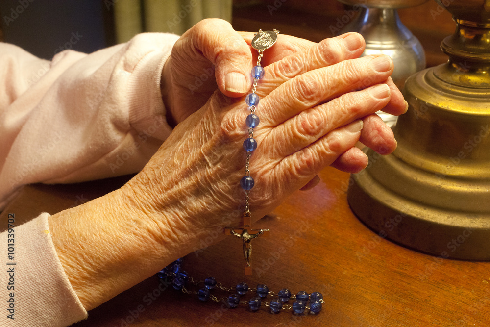 Elderly hands praying with Rosary Beads Stock Photo | Adobe Stock