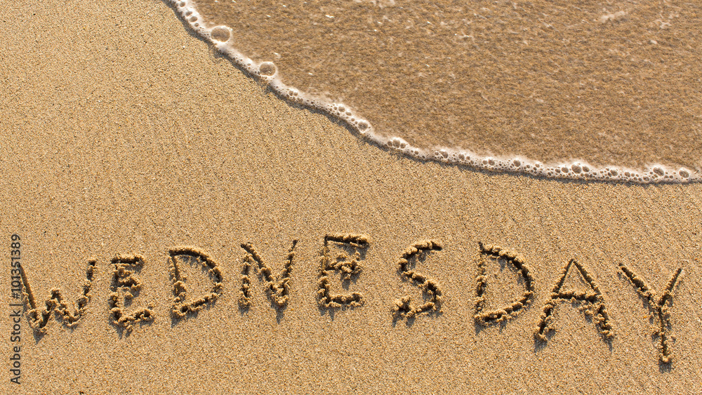 Inscription WEDNESDAY on a gentle beach sand with the soft wave (days ...