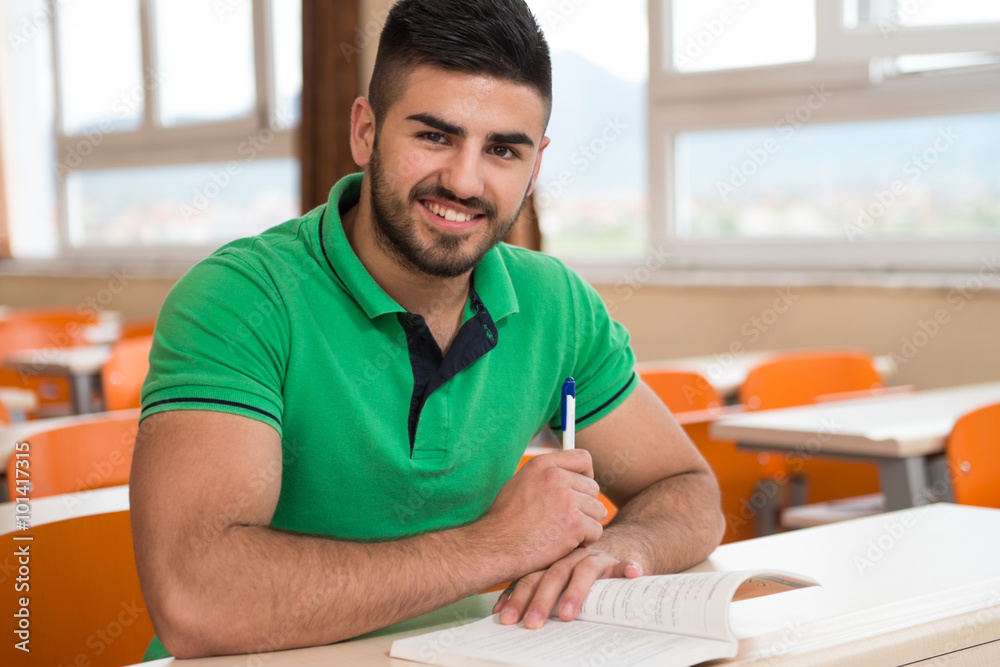 Arabic Student With Books Sitting In Classroom Stock Photo | Adobe Stock