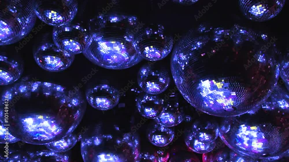 Mirror balls reflect rays of colored lights. Colorful reflective disco ...
