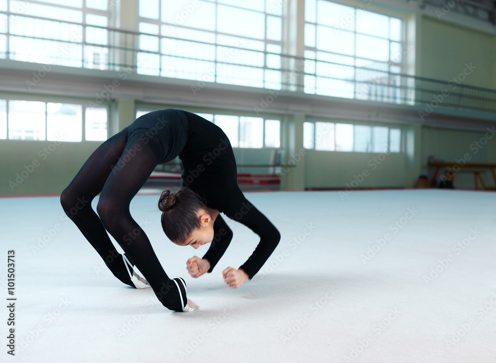 gymnast in black suit making a somersault Stock Photo | Adobe Stock
