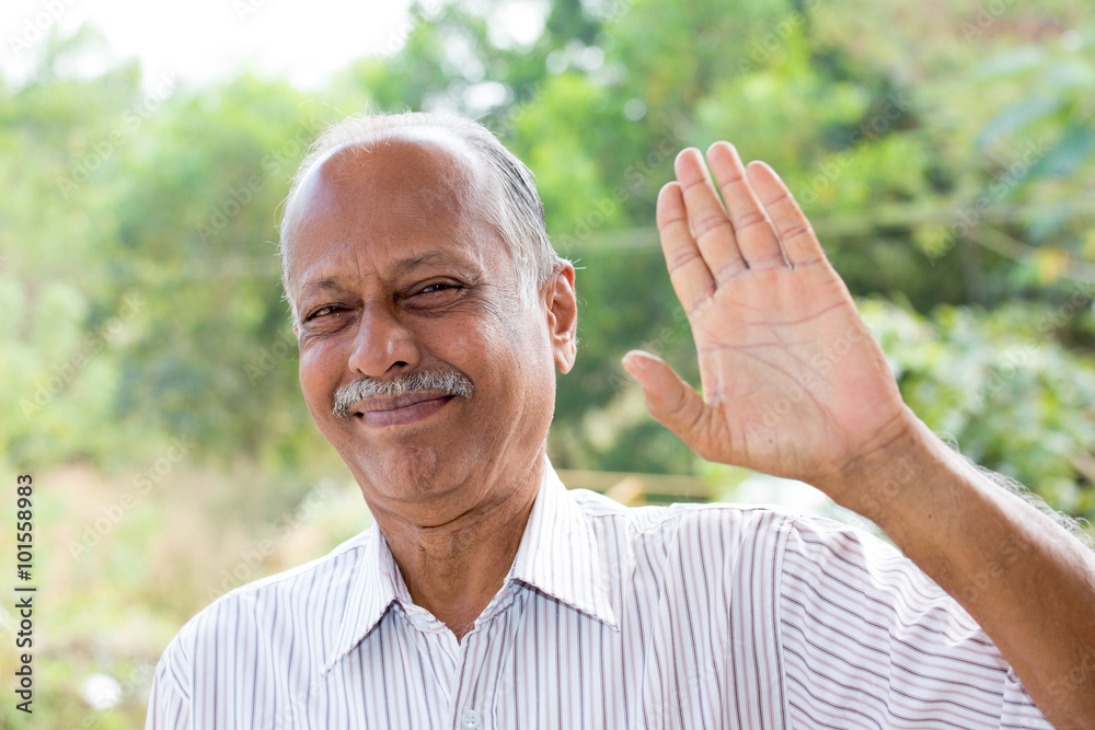 Closeup portrait, amiable old man waving hi or farewell, isolated ...