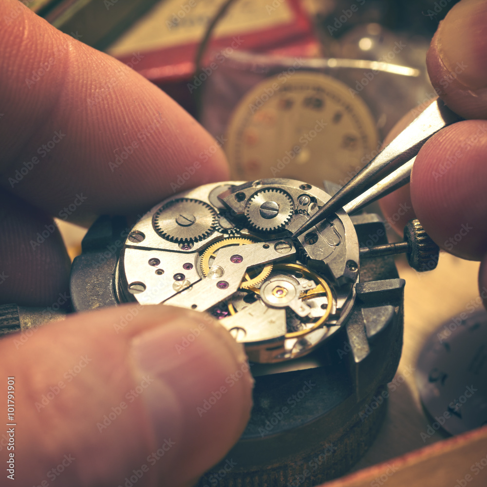 Working On A Mechanical Watch. A watch makers work top. The inside ...