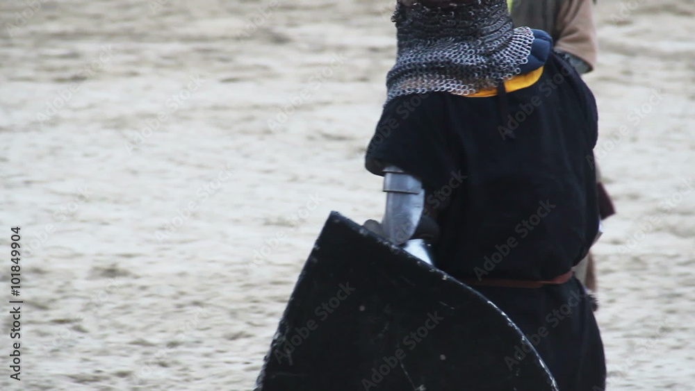 Sword fight between two men wearing historic armor suits and steel ...