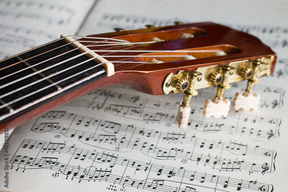 Guitar headstock on music notes Stock Photo | Adobe Stock