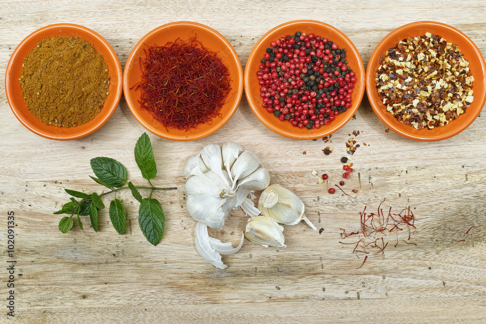 Four bowls with saffron, pepper, ras en hanout, fresh mint and Stock ...