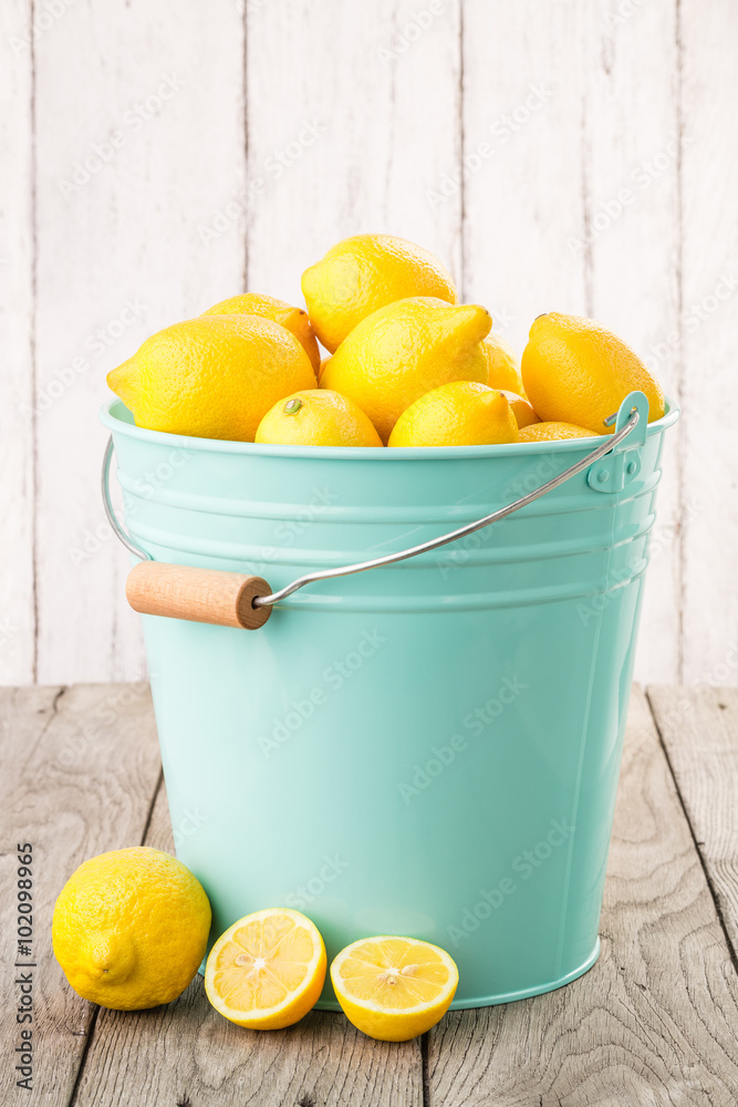 Fresh lemons in the metal bucket. Stock Photo | Adobe Stock