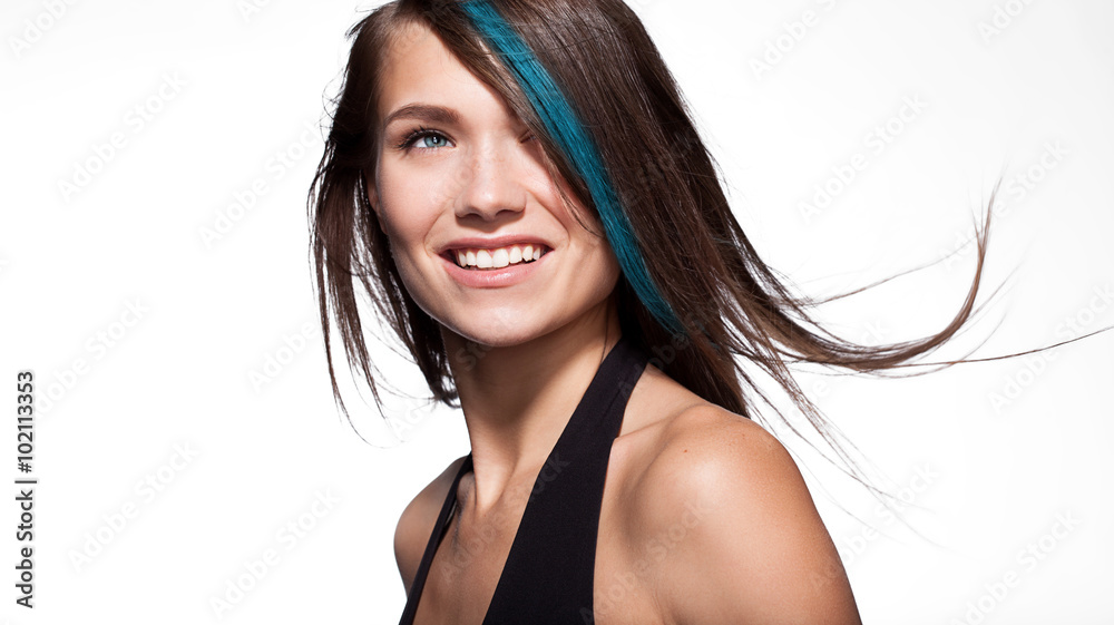 Portrait of a smiling girl with long hair color on a white background ...