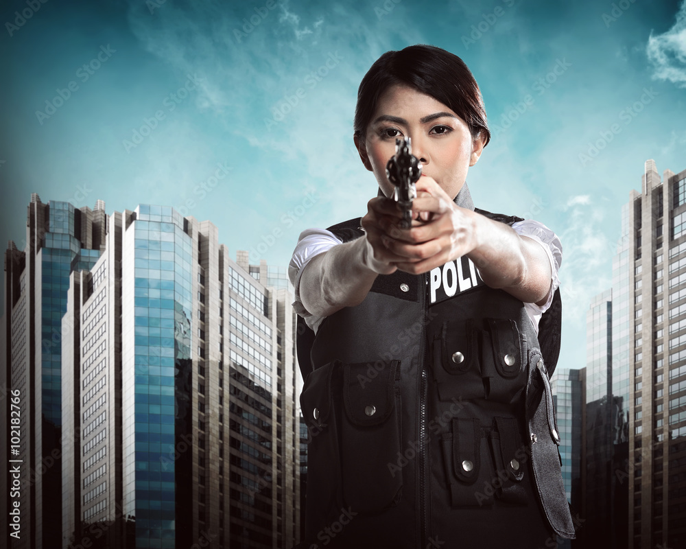 Beautiful police woman holding gun Stock Photo | Adobe Stock