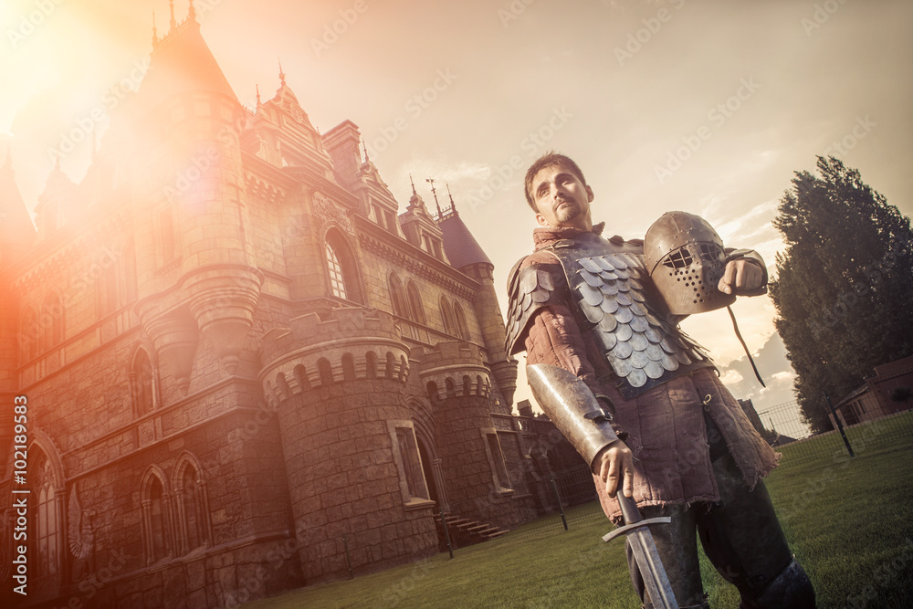 Medieval knight with the sword on the ancient castle background Stock ...