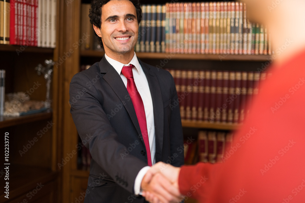 Businessman giving an handshake to a customer Stock Photo | Adobe Stock