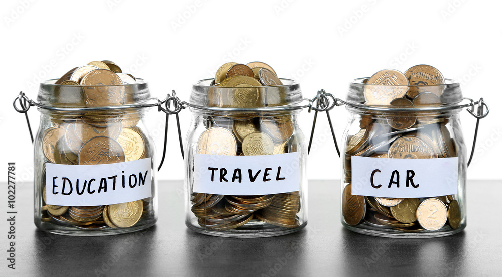 Three jars for different needs full of coins Stock Photo | Adobe Stock