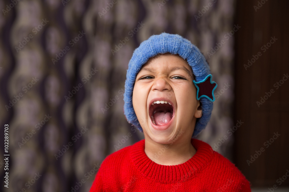 Cute Indian Kid striking a pose in winter wear with a big laugh Stock ...
