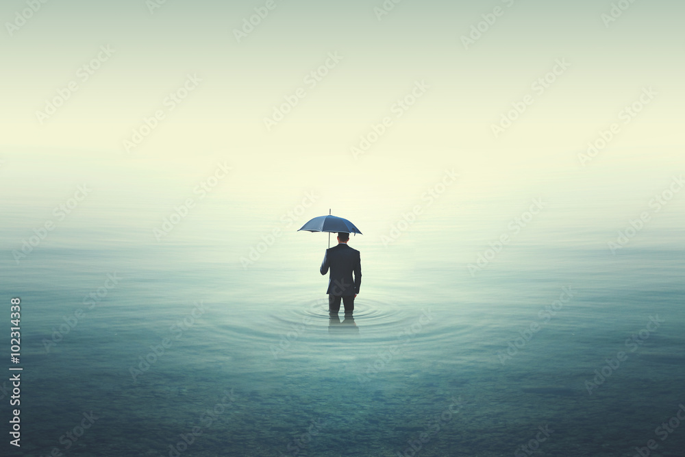 Wet business man walking into water Stock Photo | Adobe Stock