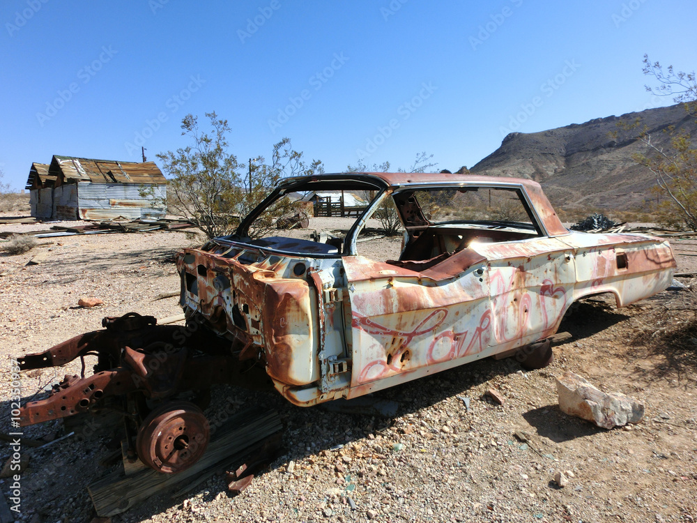 Totally demolished shell of an old abandoned car with rust - landscape ...