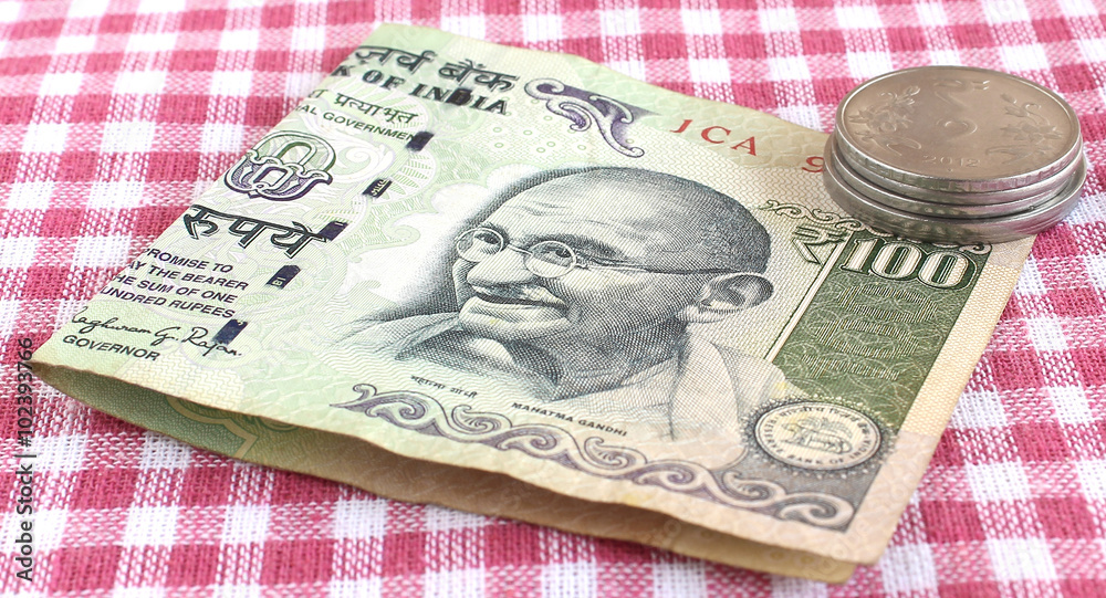 Indian currency one hundred rupee with Gandhi emblem and a stack of ...