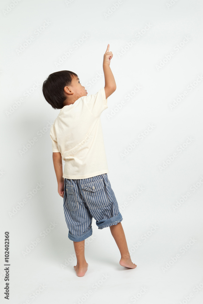 child pointing at side. Back view. Isolated on white background Stock ...