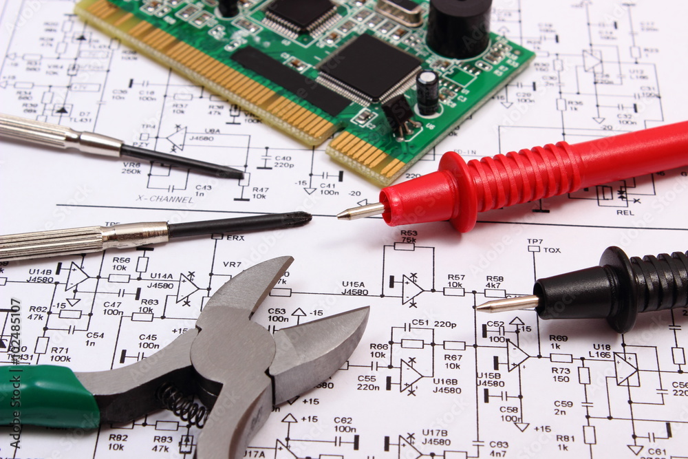 Printed circuit board. precision tools and cable of multimeter on ...