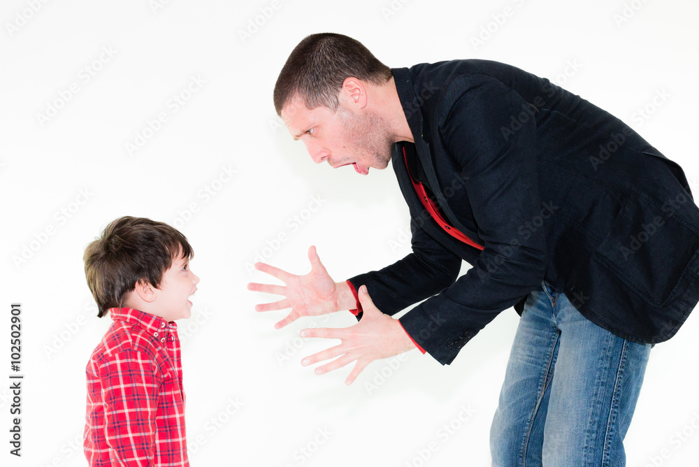 portrait of angry father scolding his son pointing finger, isolated on ...