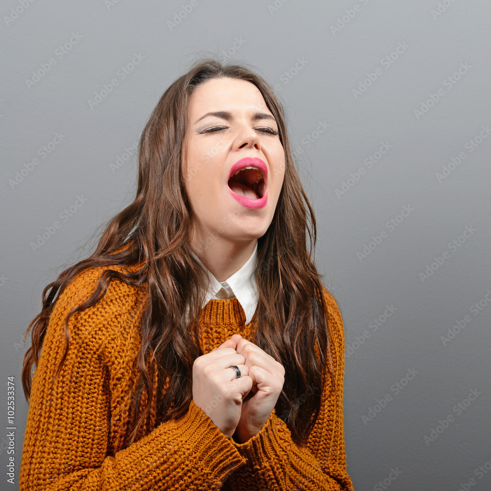 Woman praying about something or begging for mercy against gray Stock ...
