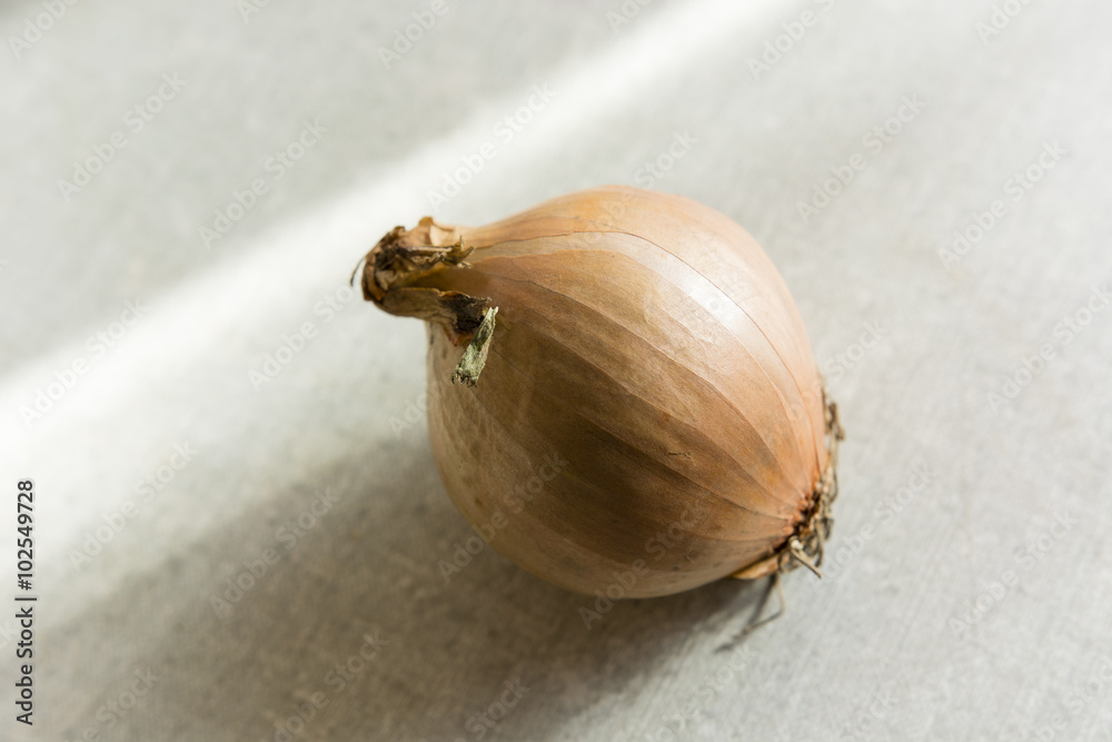 onions lying on a kitchen counter in their natural packaging paddy ...