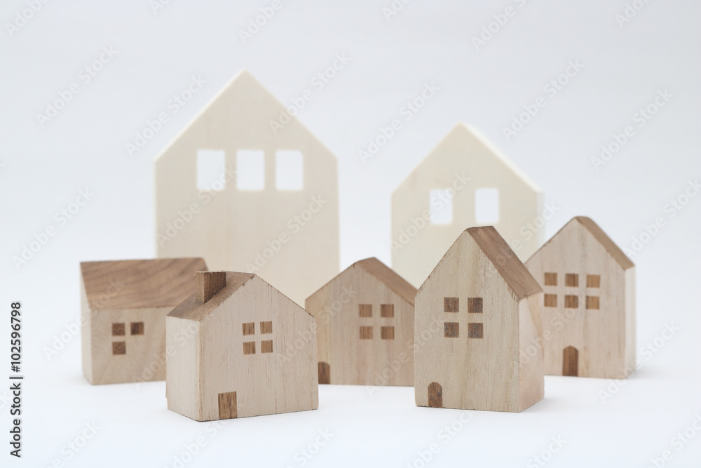 Miniature houses on white background. Building blocks arranged in row ...