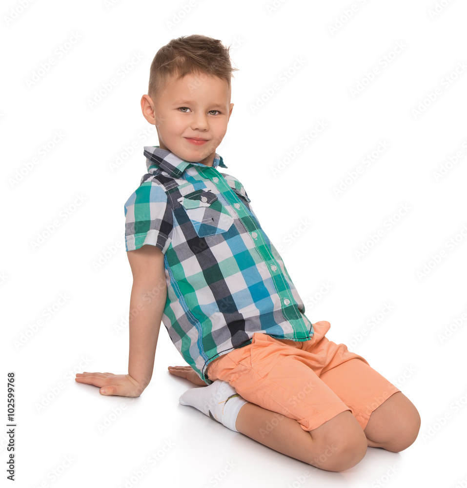 Beautiful little blond boy with a fashionable haircut, wearing a ...
