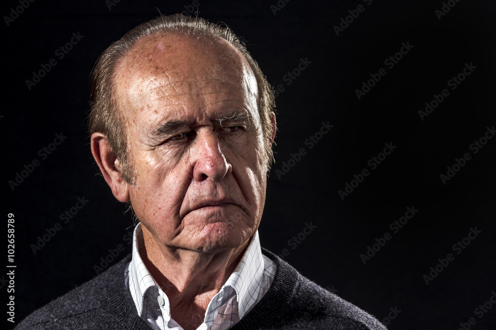 Grandpa gets serious. Old man looks with angry face, on black ...