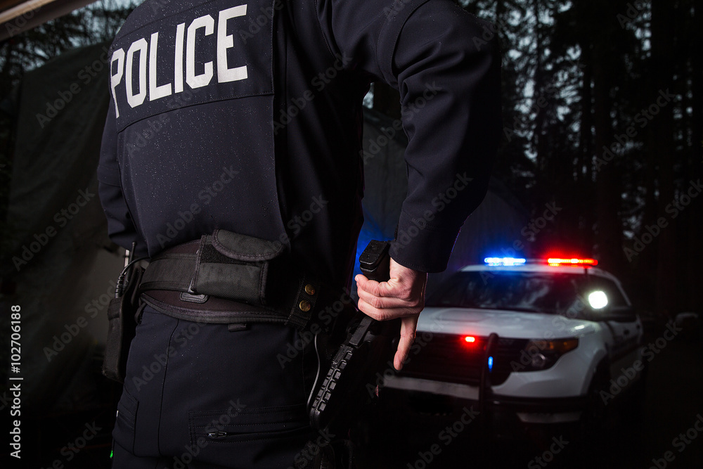 Police Officer grabbing his gun Stock Photo | Adobe Stock
