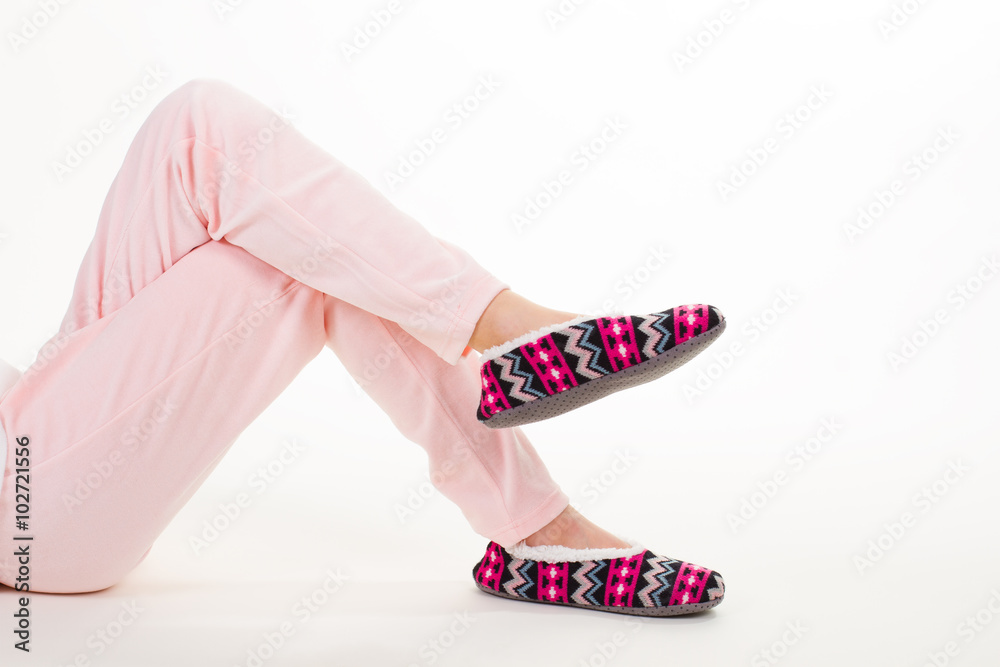 Female legs in pajama pants and slippers. Stock Photo | Adobe Stock