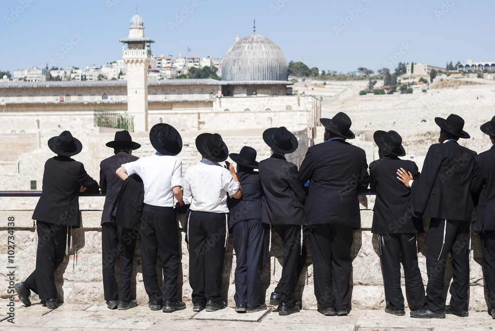 A group of Ultra Orthodox Jews, yeshiva students standing in front of ...